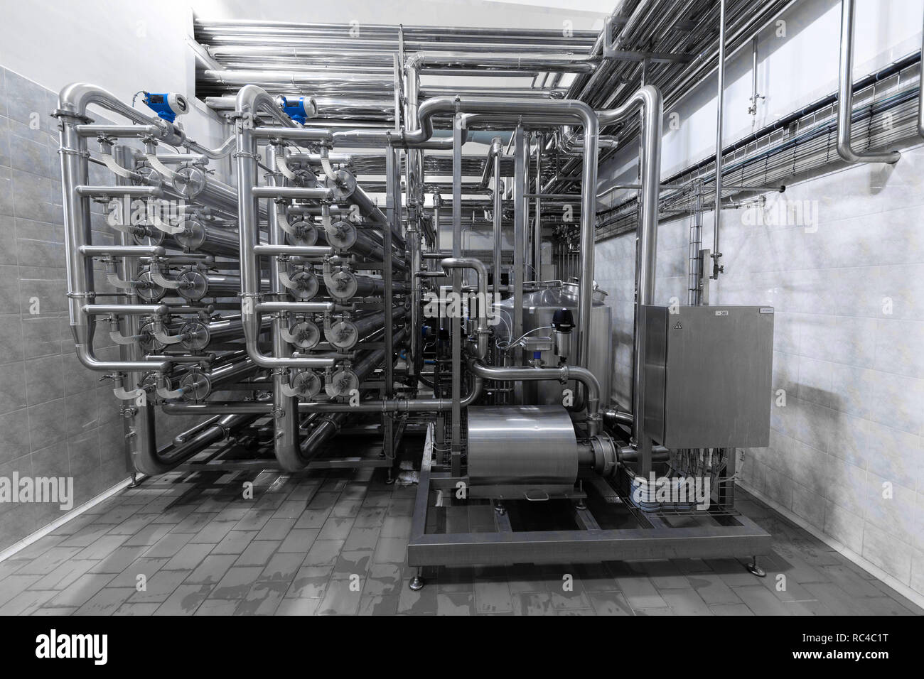 Industrial pipelines and modern equipment in cheese production interior ...