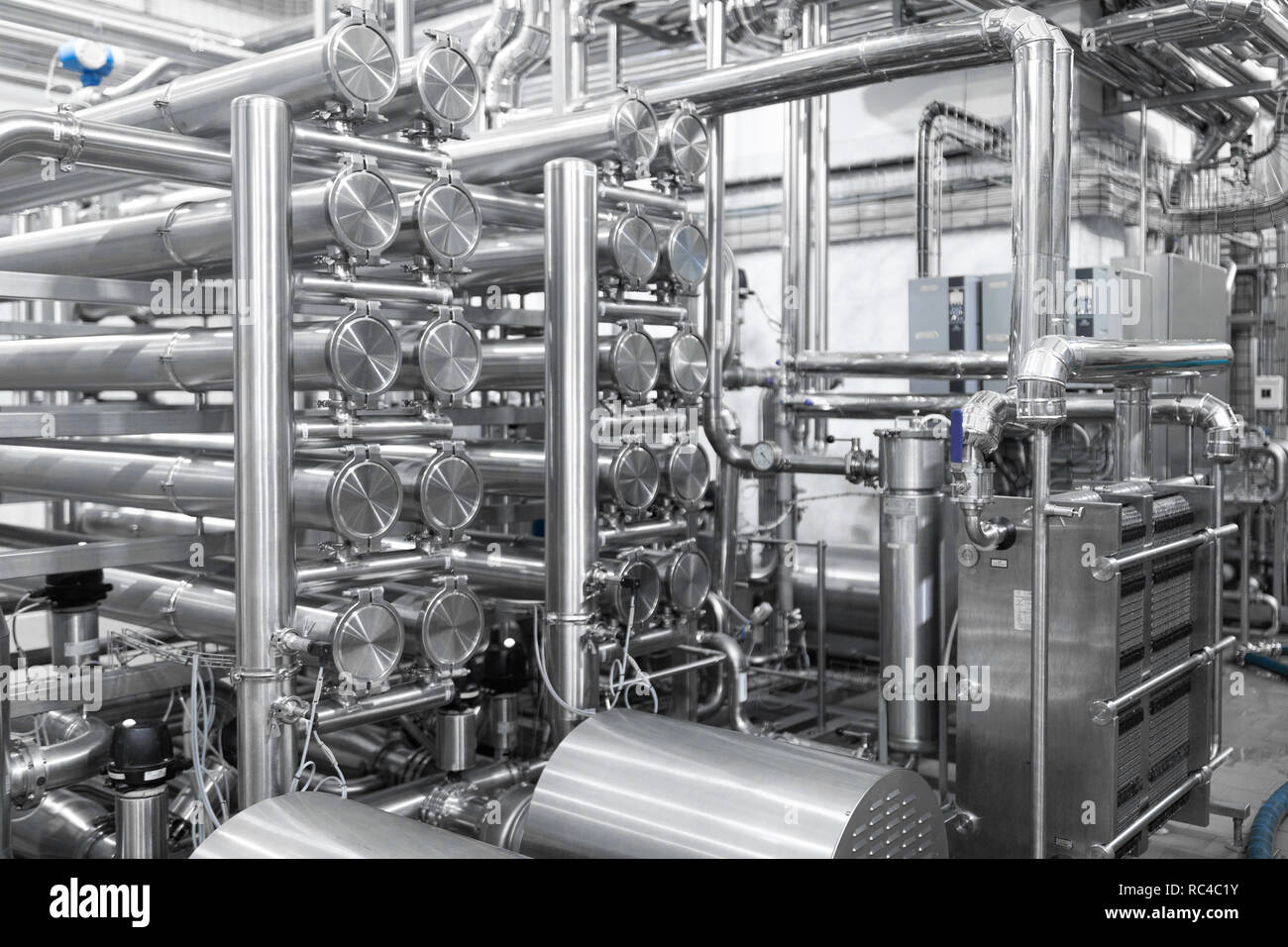 Industrial pipelines and modern equipment in cheese production interior ...