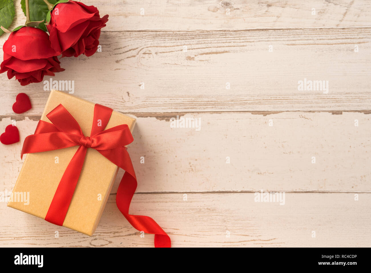 Kraft gift box with red ribbon bow, concept of giving present and ...