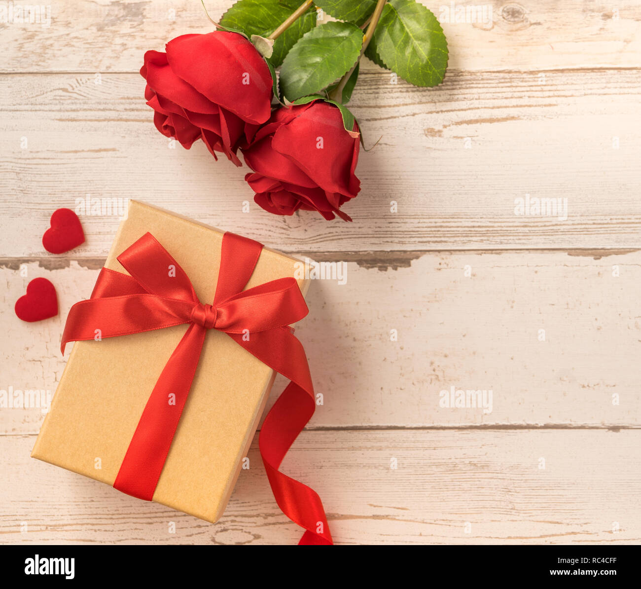 Kraft gift box with red ribbon bow, concept of giving present and ...