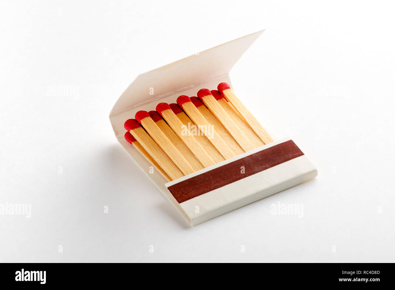 Open matchbox book, full of matches with red heads. Isolated on white ...