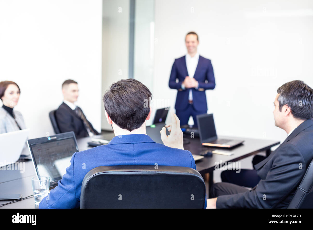 Businessman asking question colleague hi-res stock photography and ...