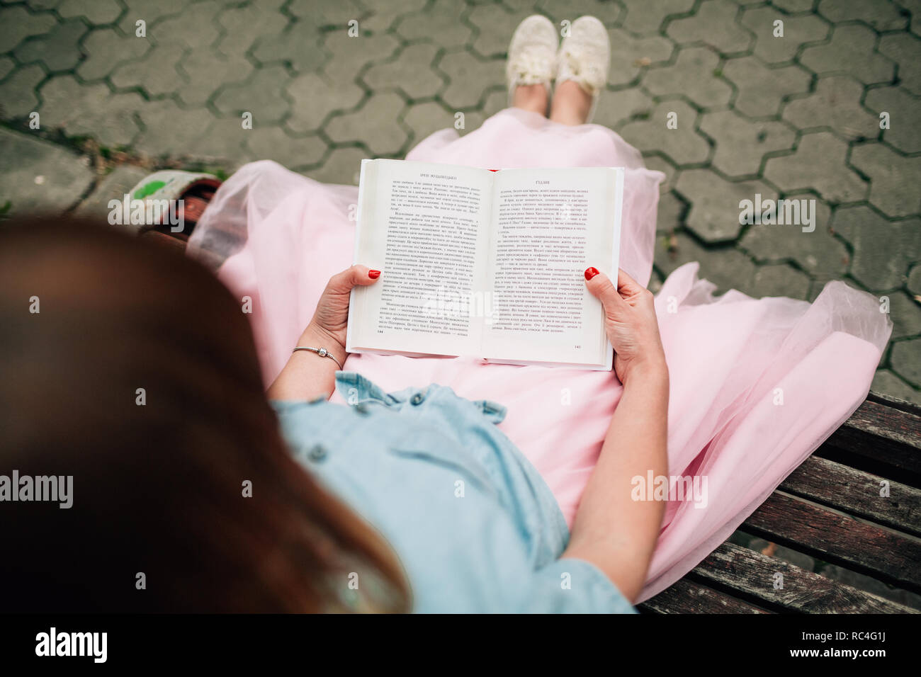 Top view of a woman reading a book Stock Photo - Alamy