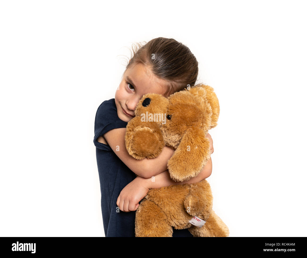 Happy preschool girl cuddling her favorite teddy bear Stock Photo - Alamy