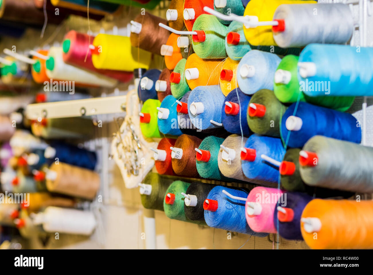 Spools of colorful Thread in sewing Studio.Selective focus.Colorful ...