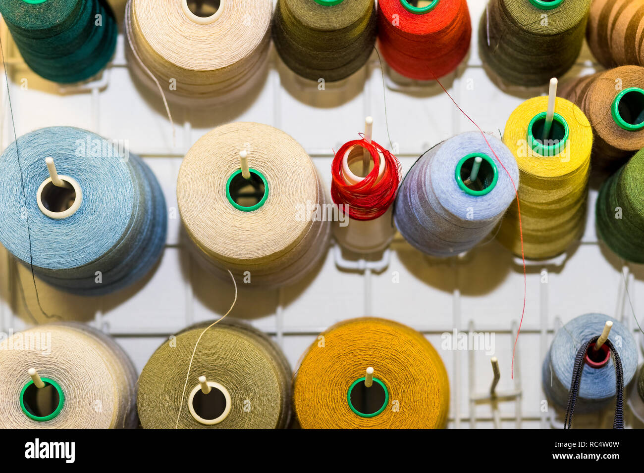 Bobbins with colorful threads on old wooden table background, Sewing ...