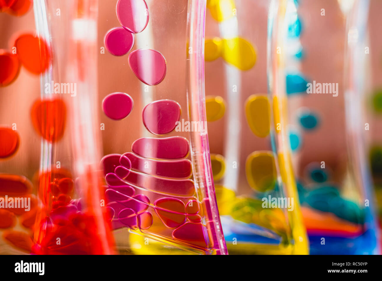 Toy with water and drops of oil colors Stock Photo - Alamy