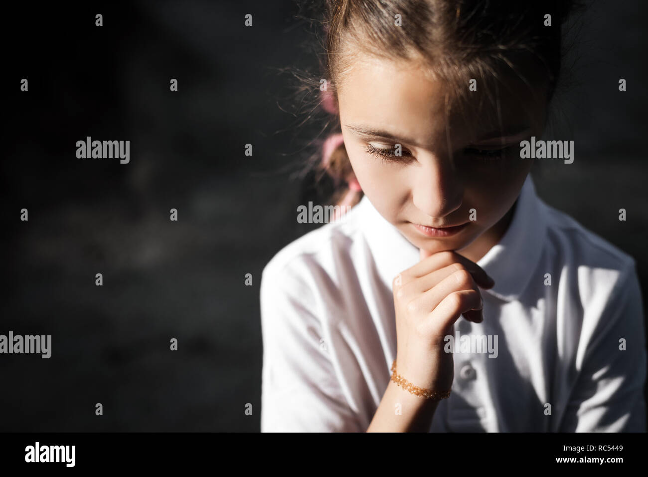 thinking child girl at night Stock Photo - Alamy