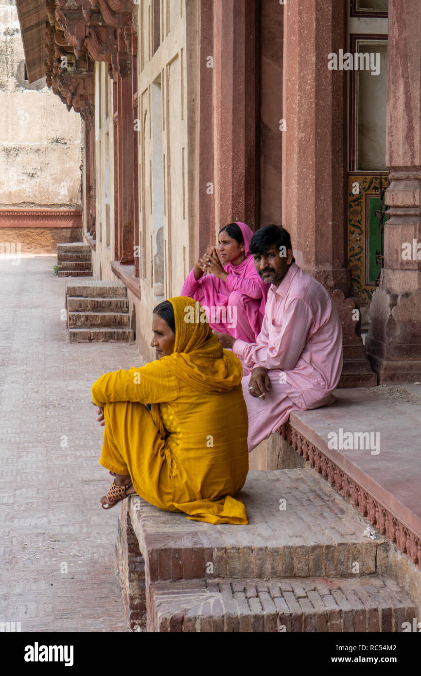 Lahore, Pakistan - August 5, 2018: Local family sitting on the street ... Lahore, Pakistan - August 5, 2018: Local family sitting on the street ...