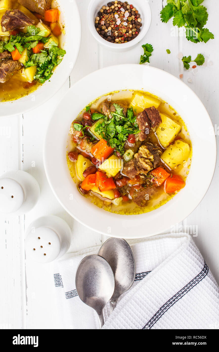 Traditional German eintopf soup with meat, beans and vegetables in a ...