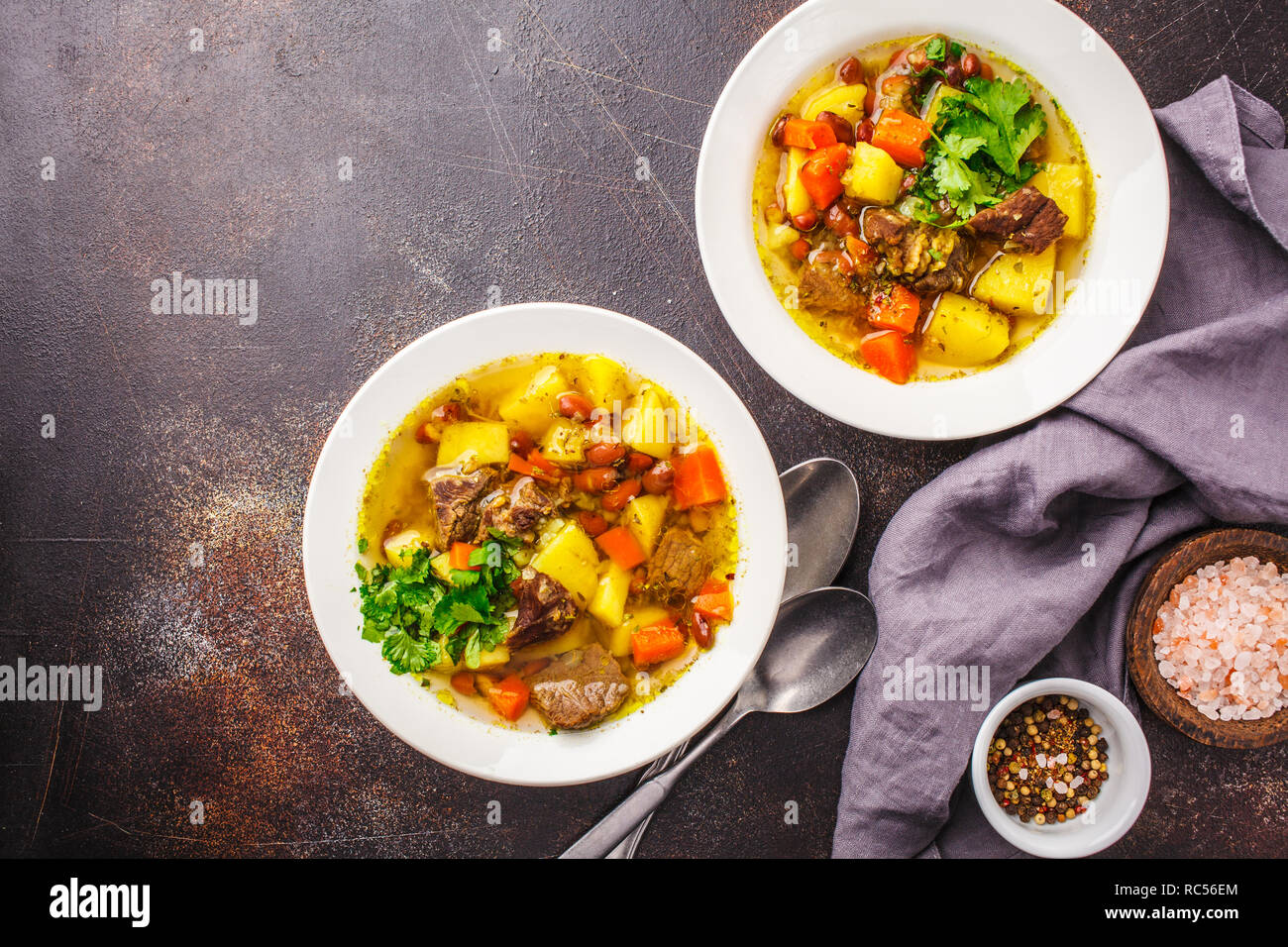 Traditional German eintopf soup with meat, beans and vegetables in a ...