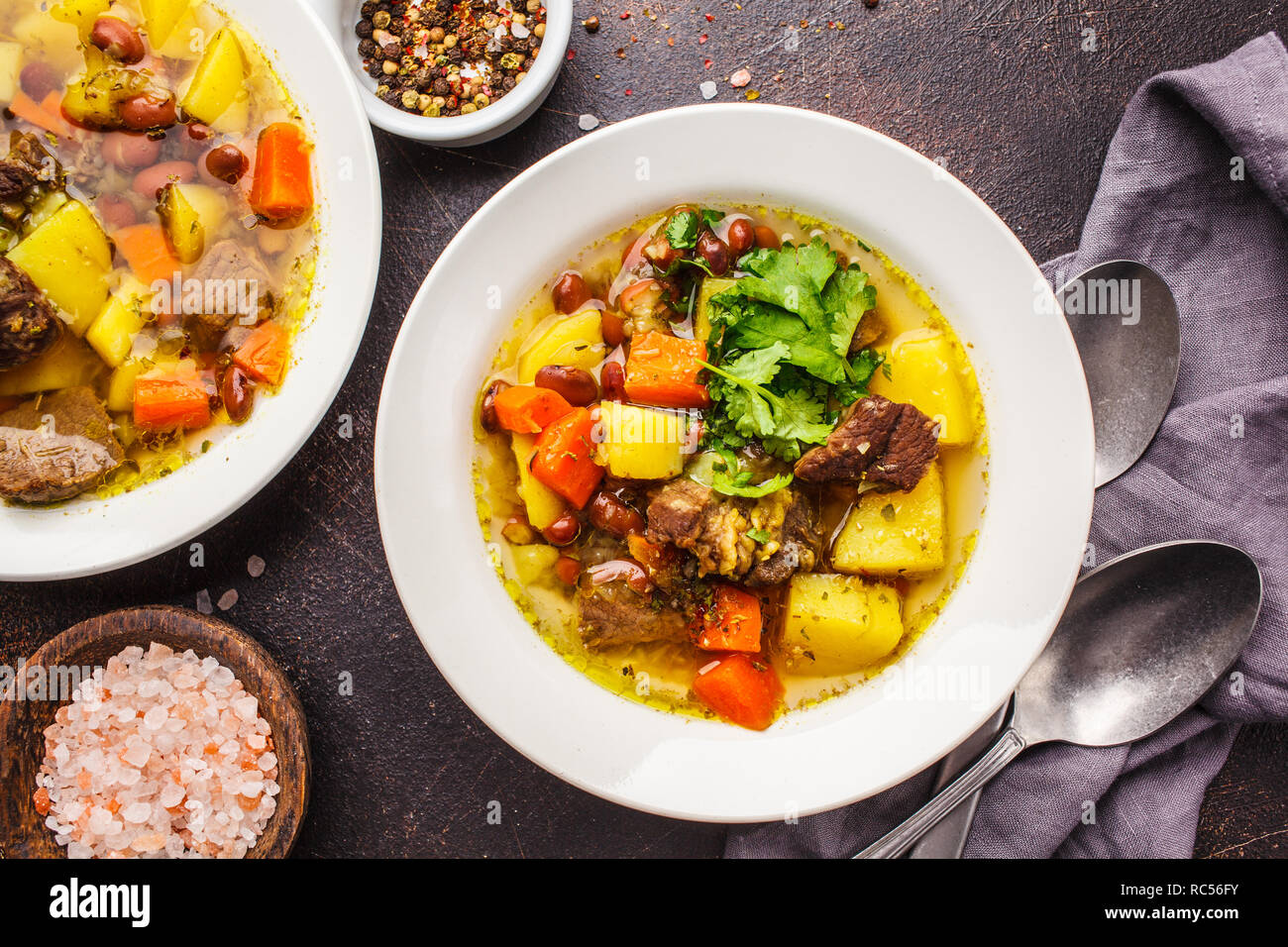 Traditional German eintopf soup with meat, beans and vegetables in a ...