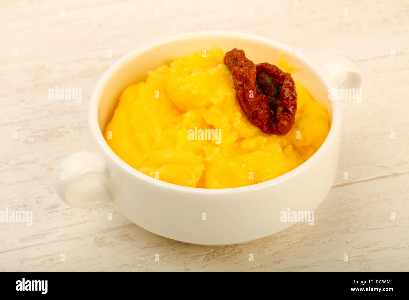 Polenta with dry tomato Stock Photo - Alamy