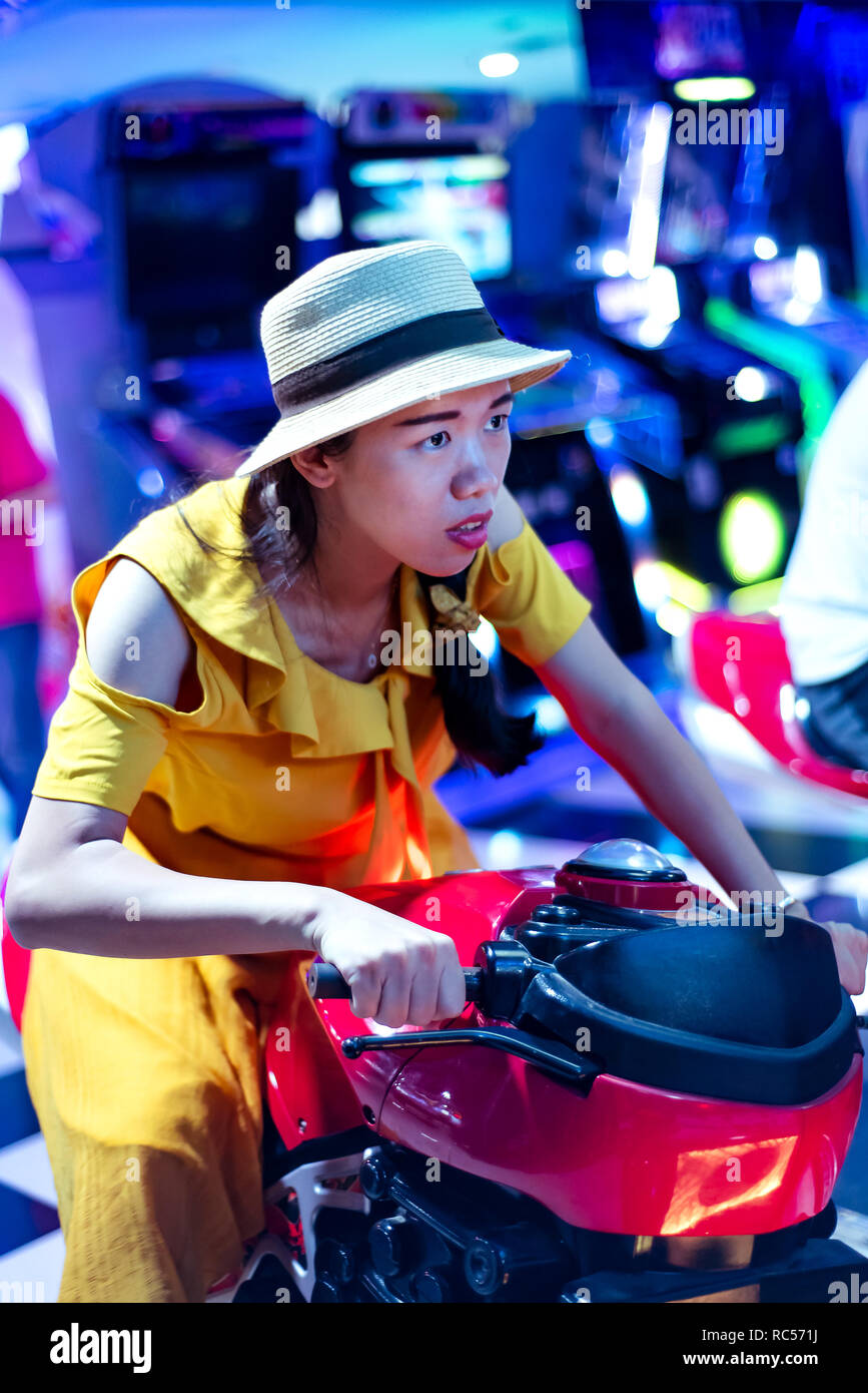 Girl playing games at arcade entertainment center Stock Photo - Alamy
