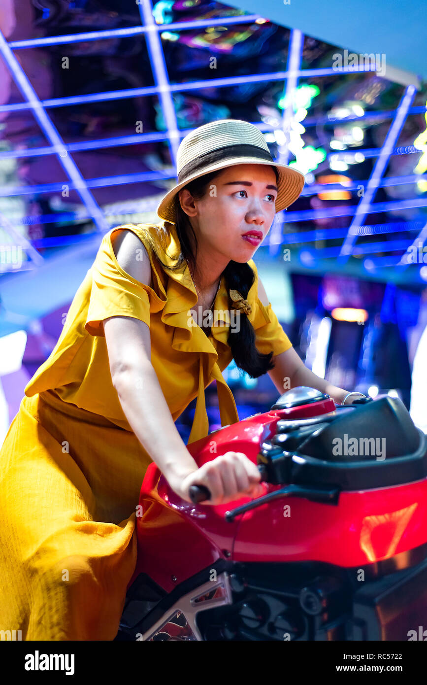 Girl playing games at arcade entertainment center Stock Photo - Alamy