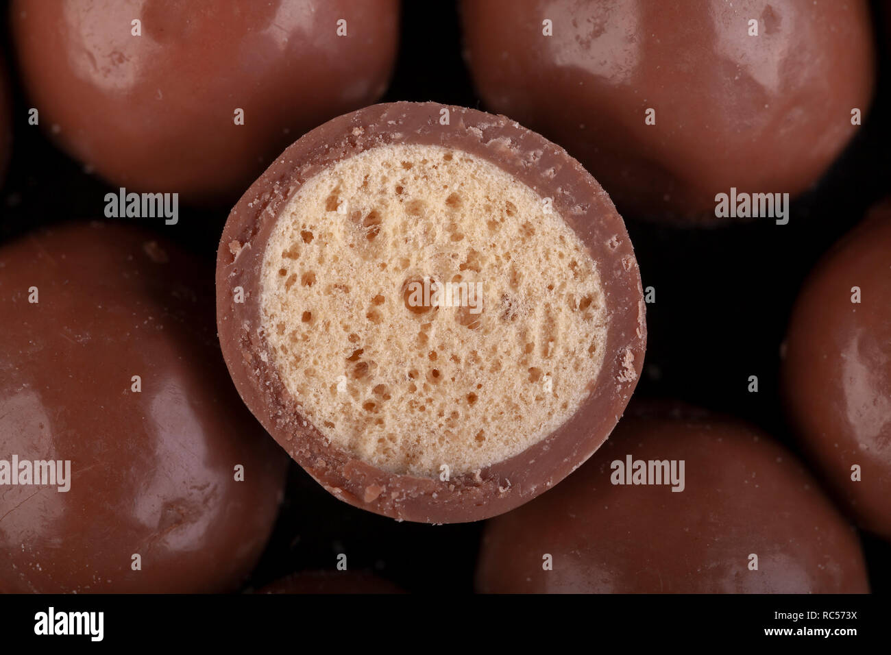 Chocolate honeycomb sweets cut in half closeup. High sugar food ...