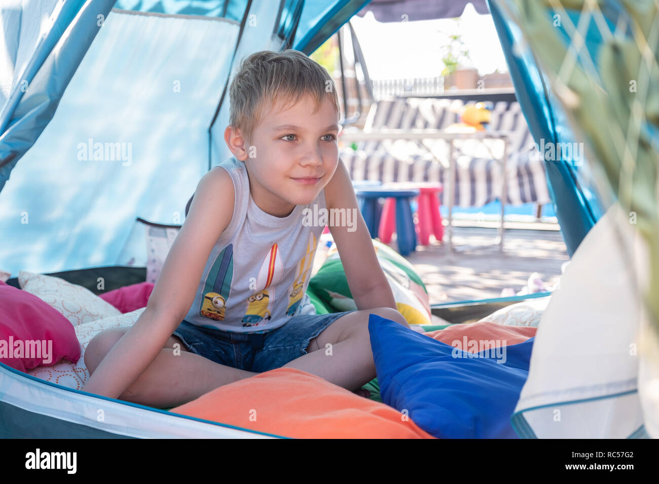 cute boys playing with pillow inside tent at backyard Stock Photo - Alamy