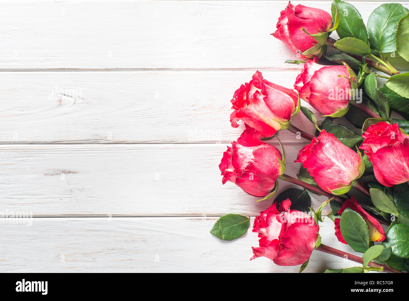 Red rose flower on wooden table Stock Photo - Alamy