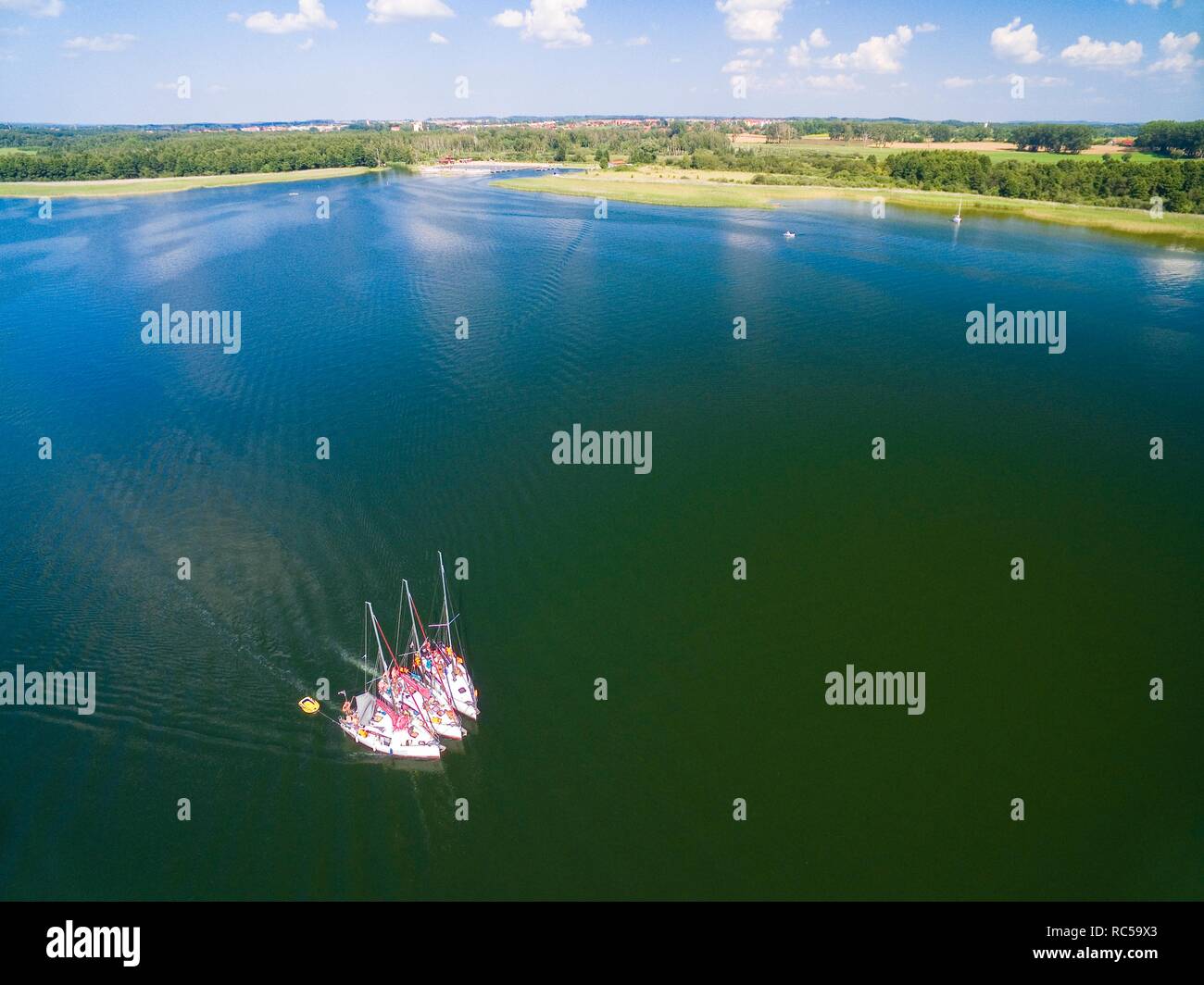 Aerial view of yachts sailing on Mamry Lake, concrete quay and town ...