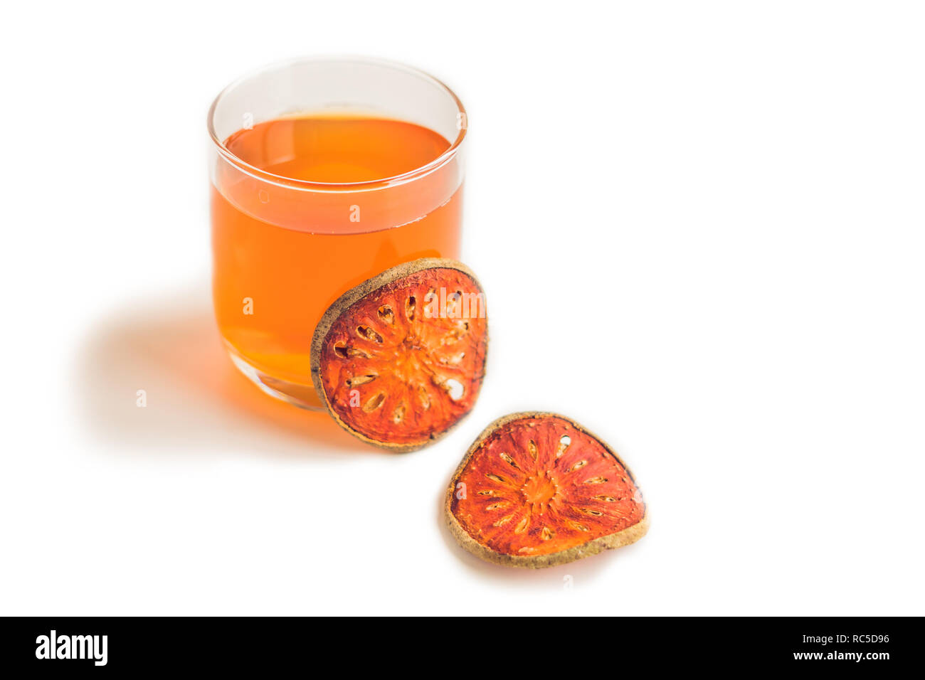 Bael fruit tea and slices of dried bael fruit, tea matum isolated on ...