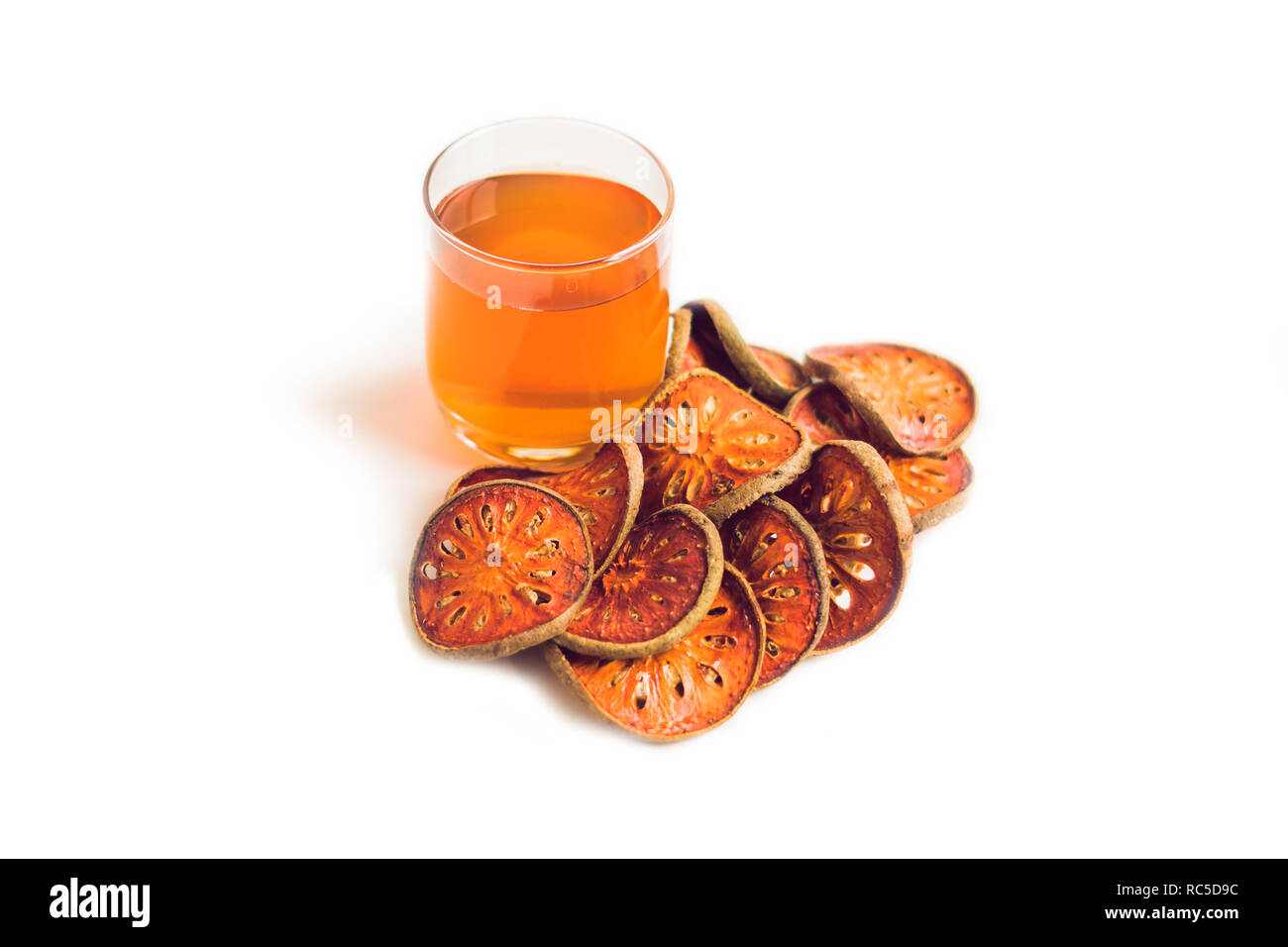 Bael fruit tea and slices of dried bael fruit, tea matum isolated on ...