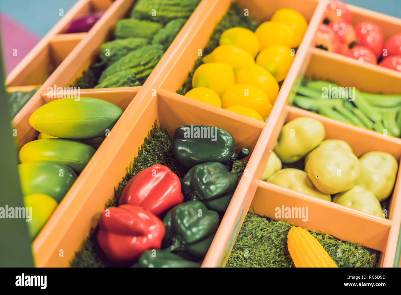 Plastic game, fake varied vegetables and fruits. Children food ...