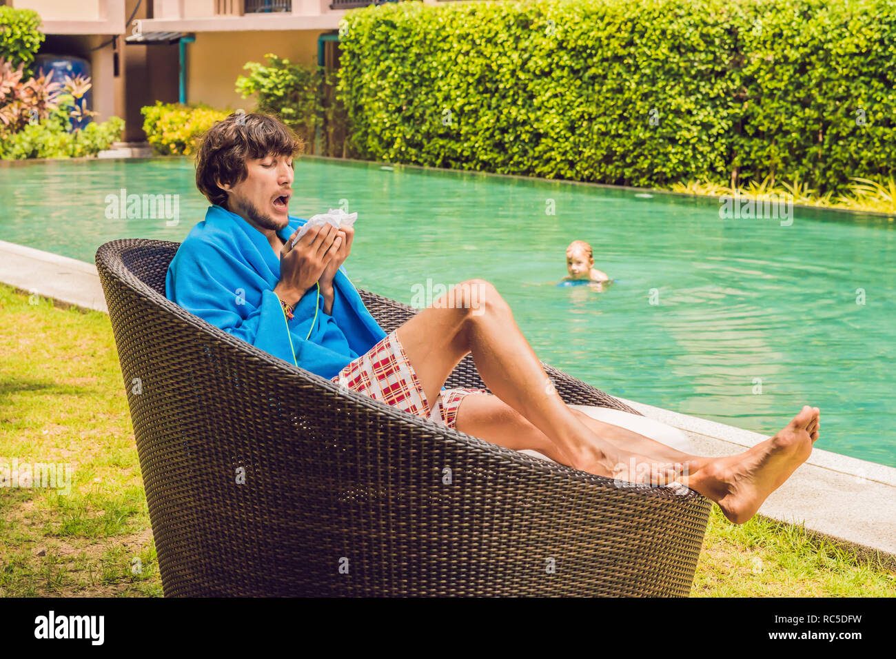 Sick man traveler. The man caught a cold on vacation, sits sad at the ...