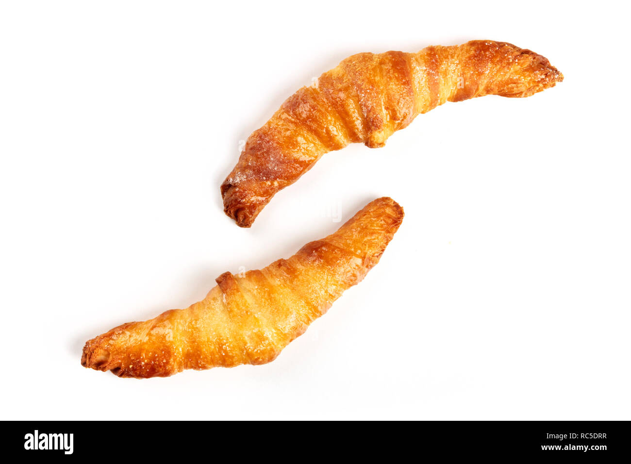 Two croissants on a white background, shot from the top, with a place ...