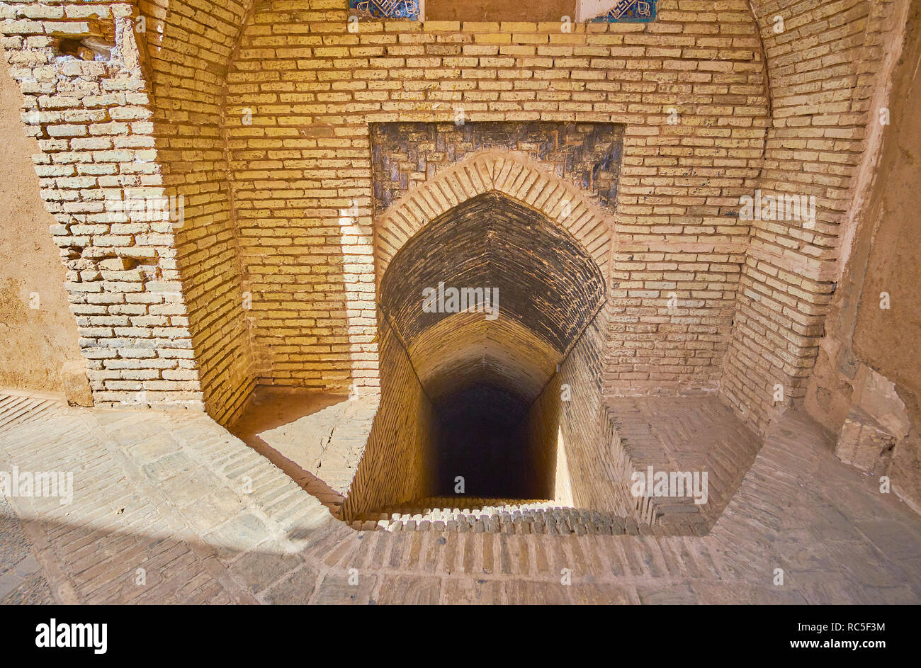 The slope with brick staircase and dark corridor of qanat (kanat, kariz ...