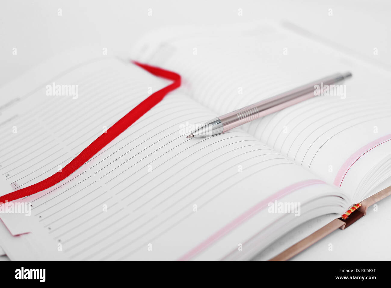 Picture of Diary with pen. Isolated on the white background Stock Photo ...