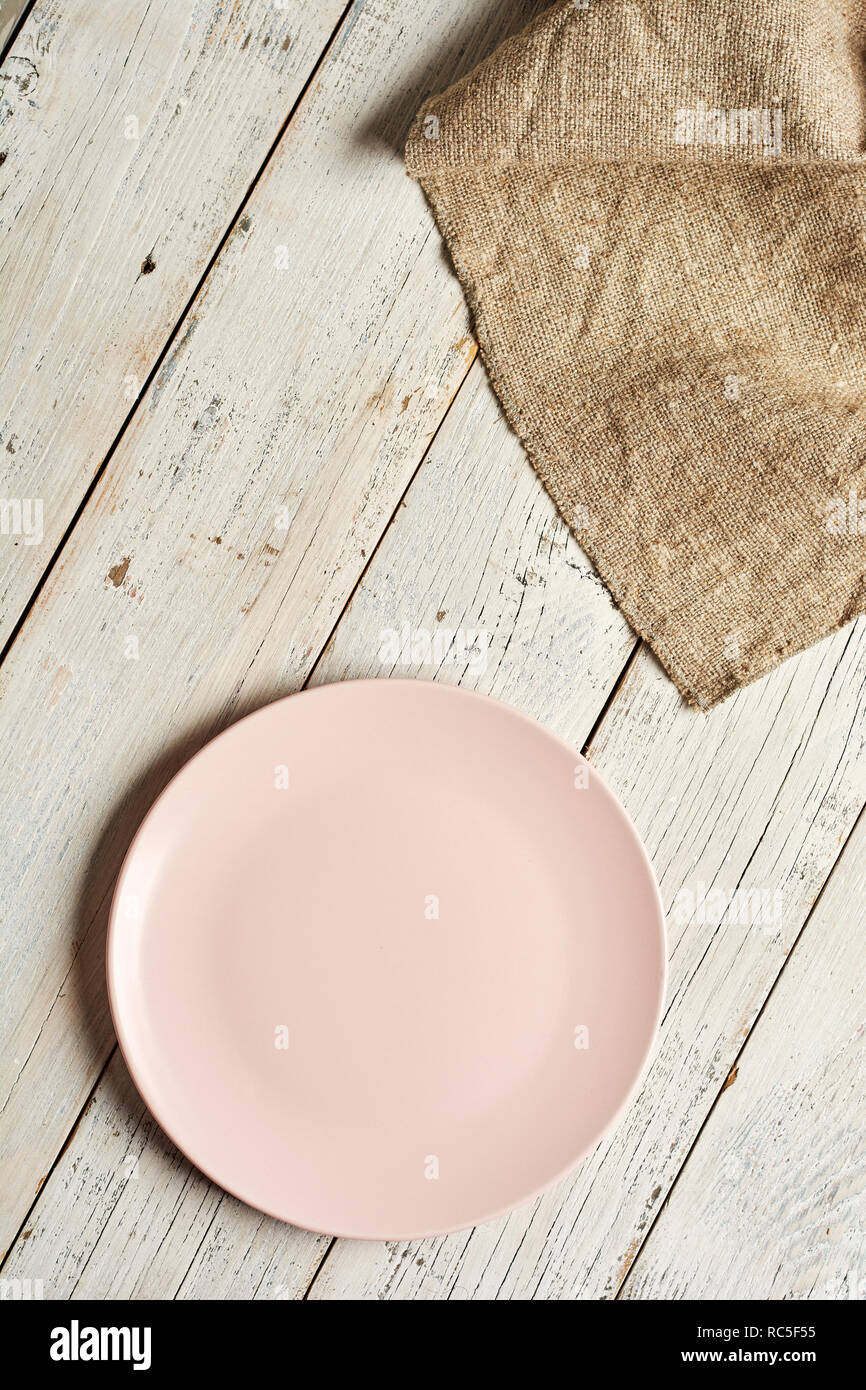 Empty plate and towel over wooden table background Stock Photo - Alamy