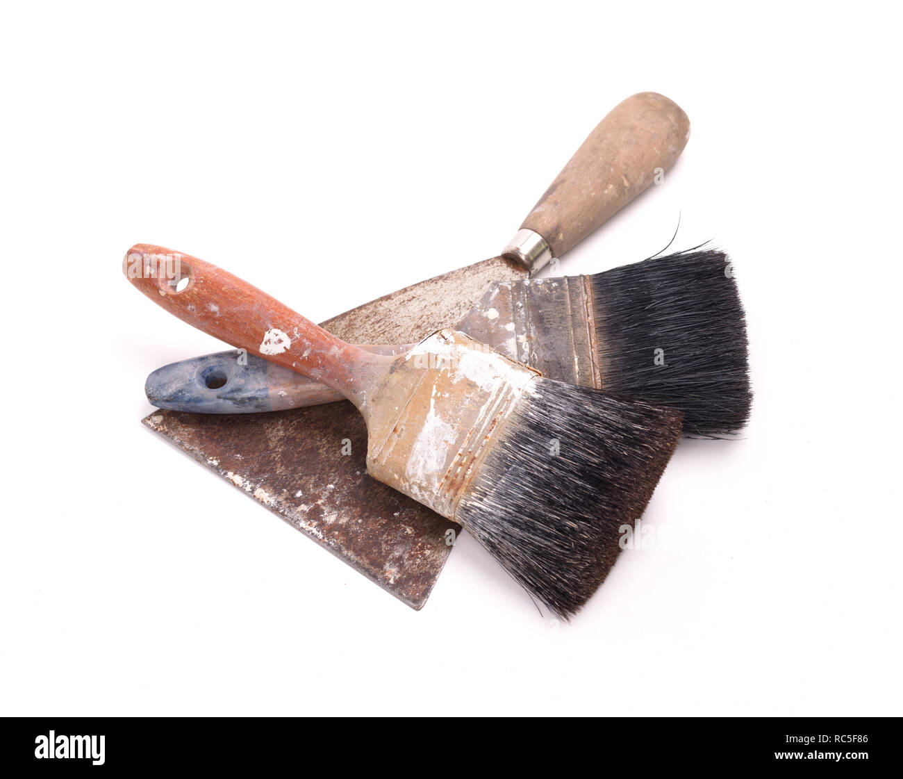 Old paintbrushes with a putty knife, isolated on a white background ...