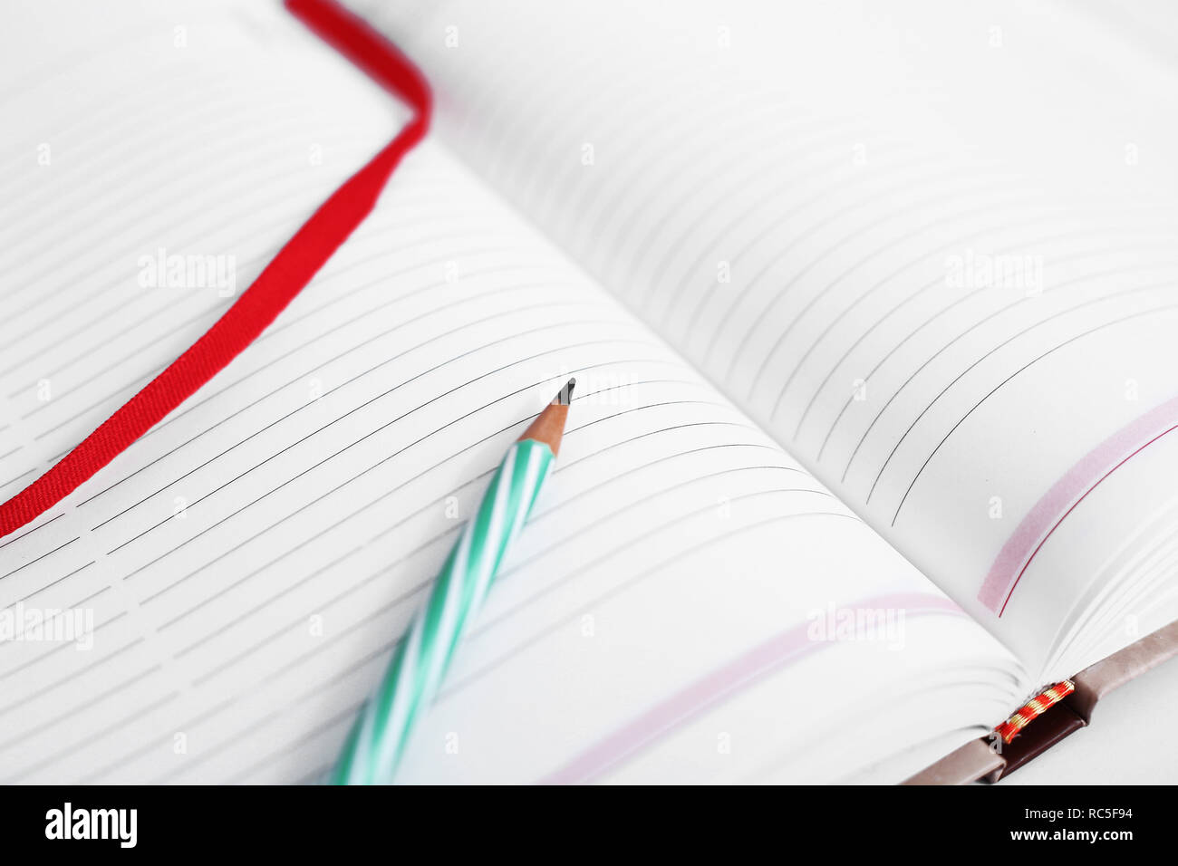 Picture of diary with pencil. Isolated on the white background Stock ...