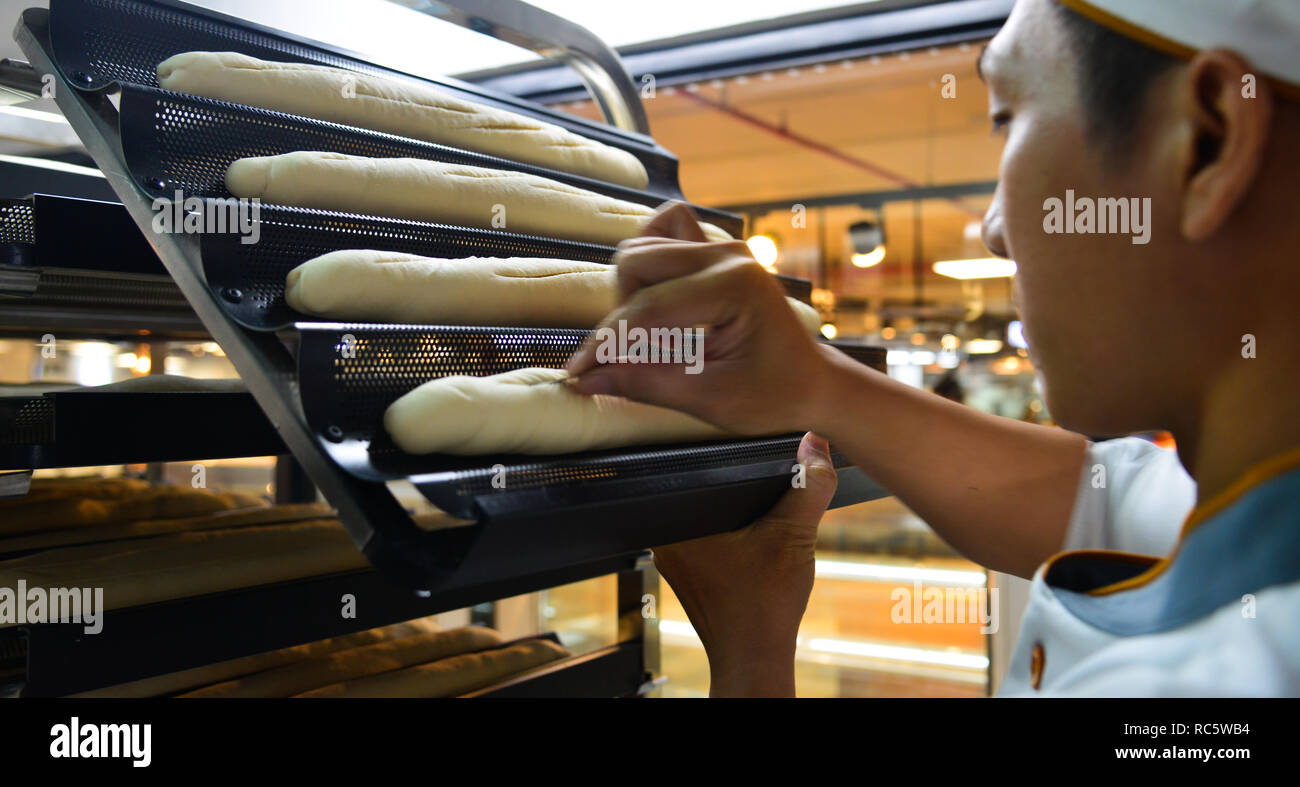 An Asian man making bread at bakery in Saigon, Vietnam Stock Photo - Alamy