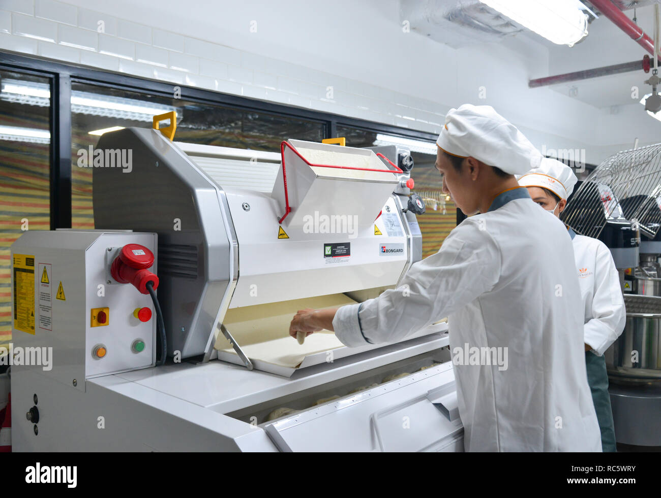 Saigon, Vietnam - Jan 9, 2019. People working at bake factory in Saigon ...