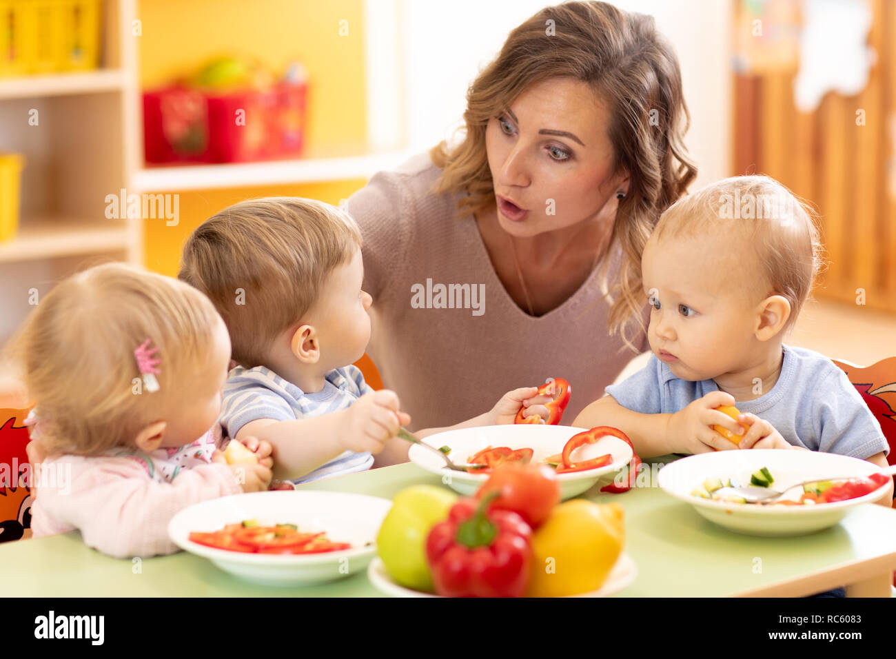 Cute little children eating healthy food at daycare centre Stock Photo ...