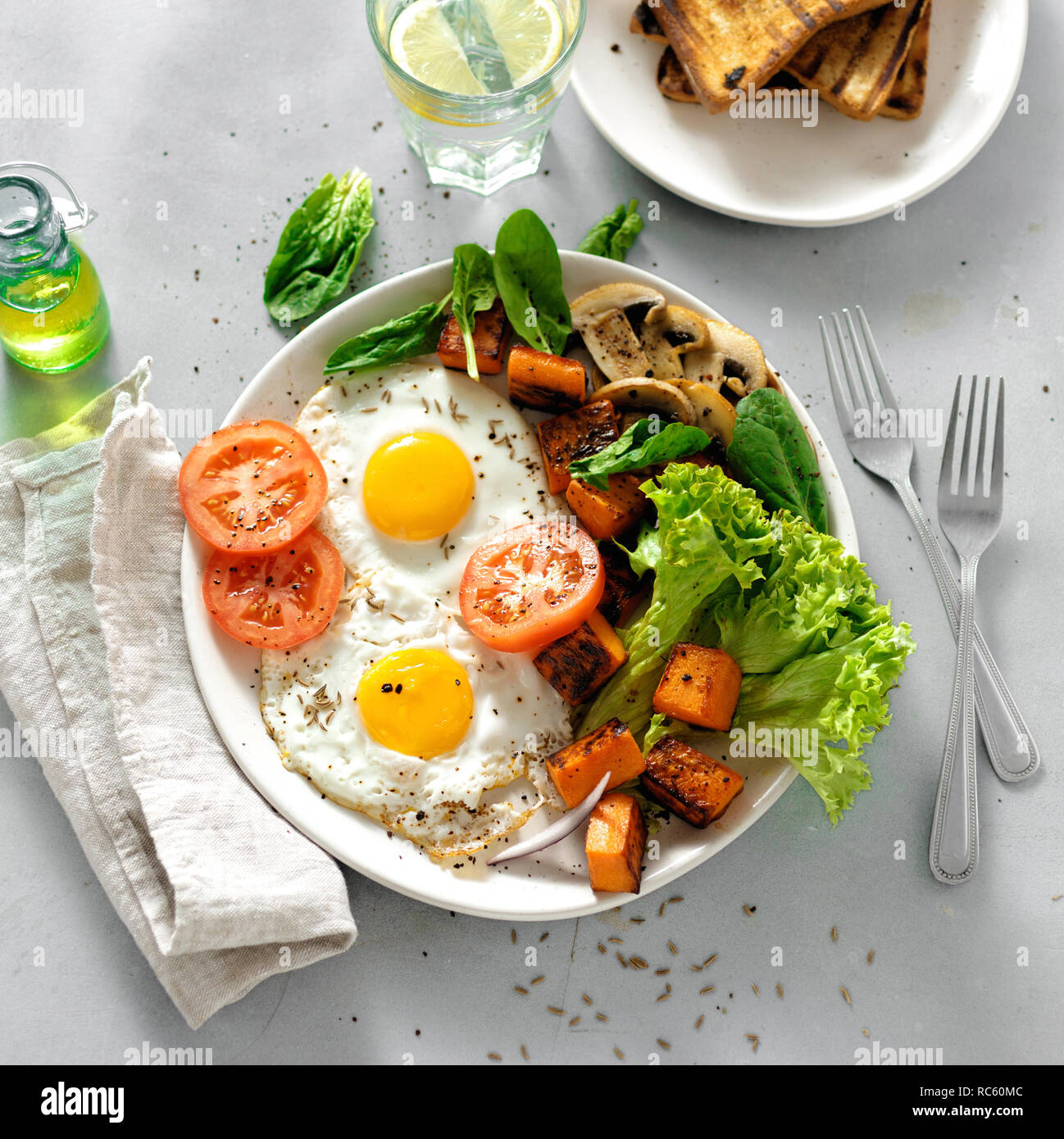Breakfast table. Breakfast plate with fried eggs, vegetables, mushrooms ...