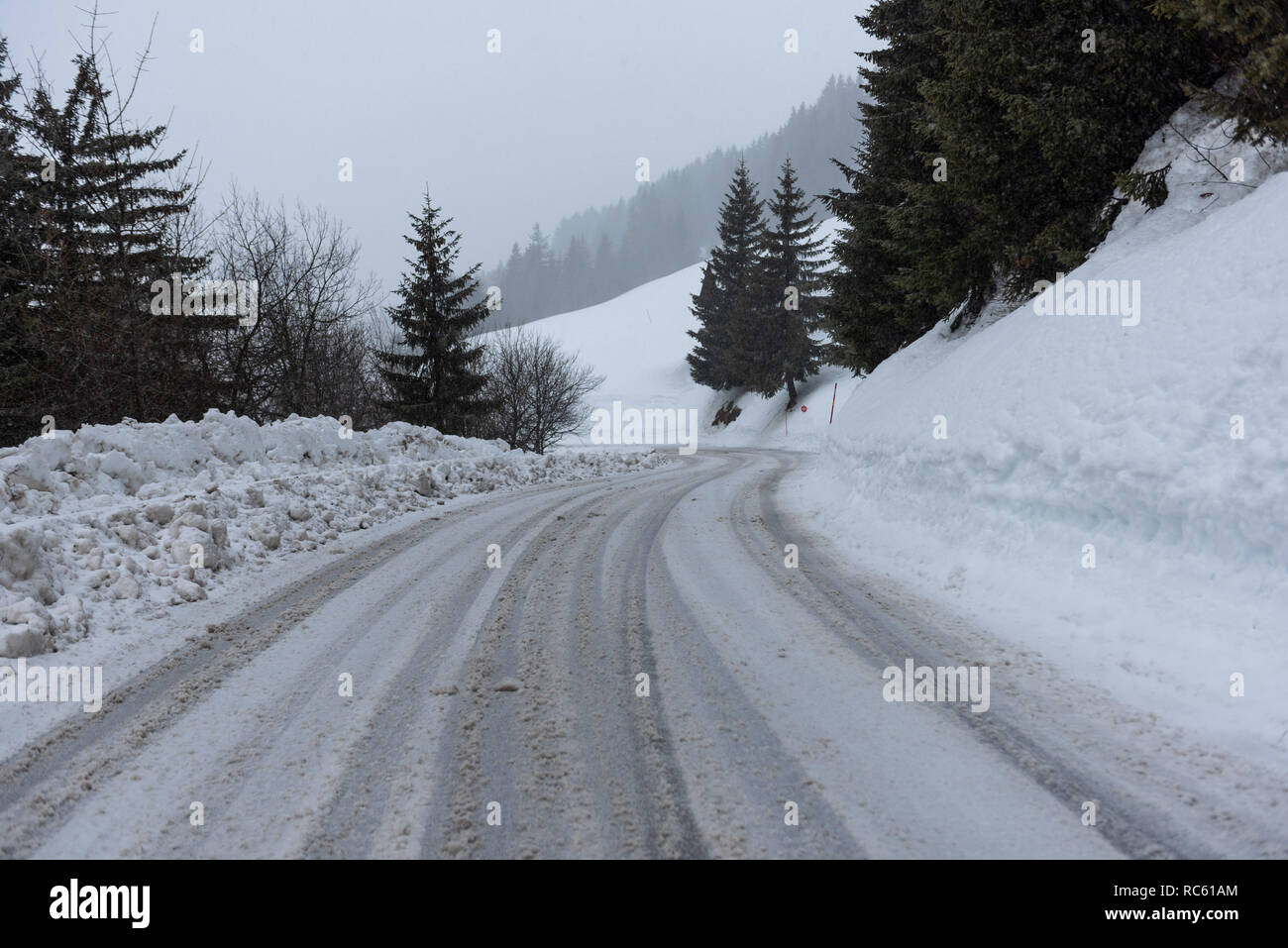 Snow covered dangerous mountain road in bad weather condition Stock ...