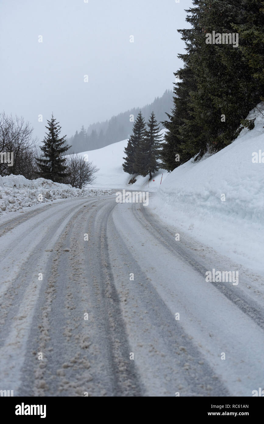 Snow covered dangerous mountain road in bad weather condition Stock ...