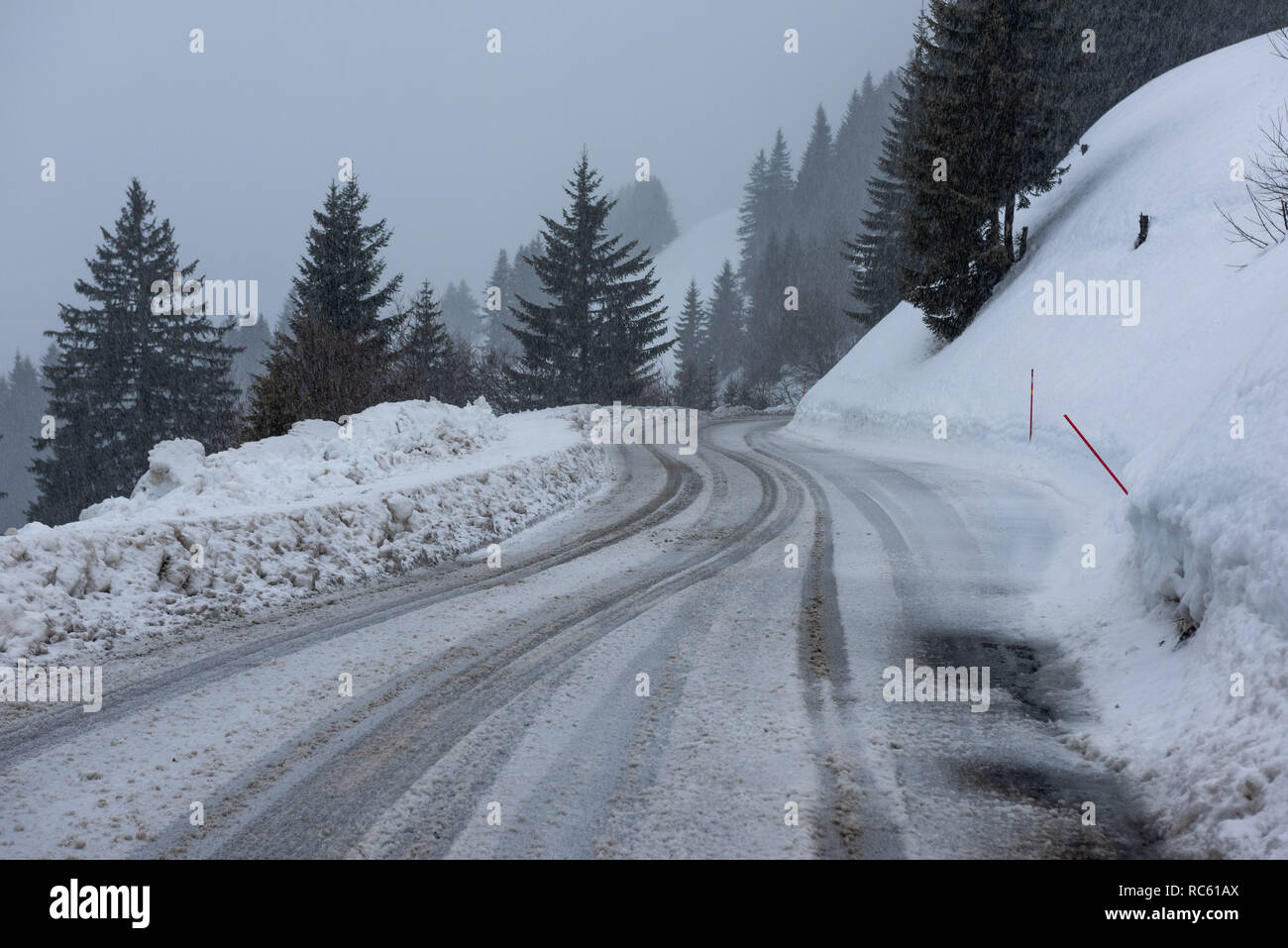 Snow covered dangerous mountain road in bad weather condition Stock ...