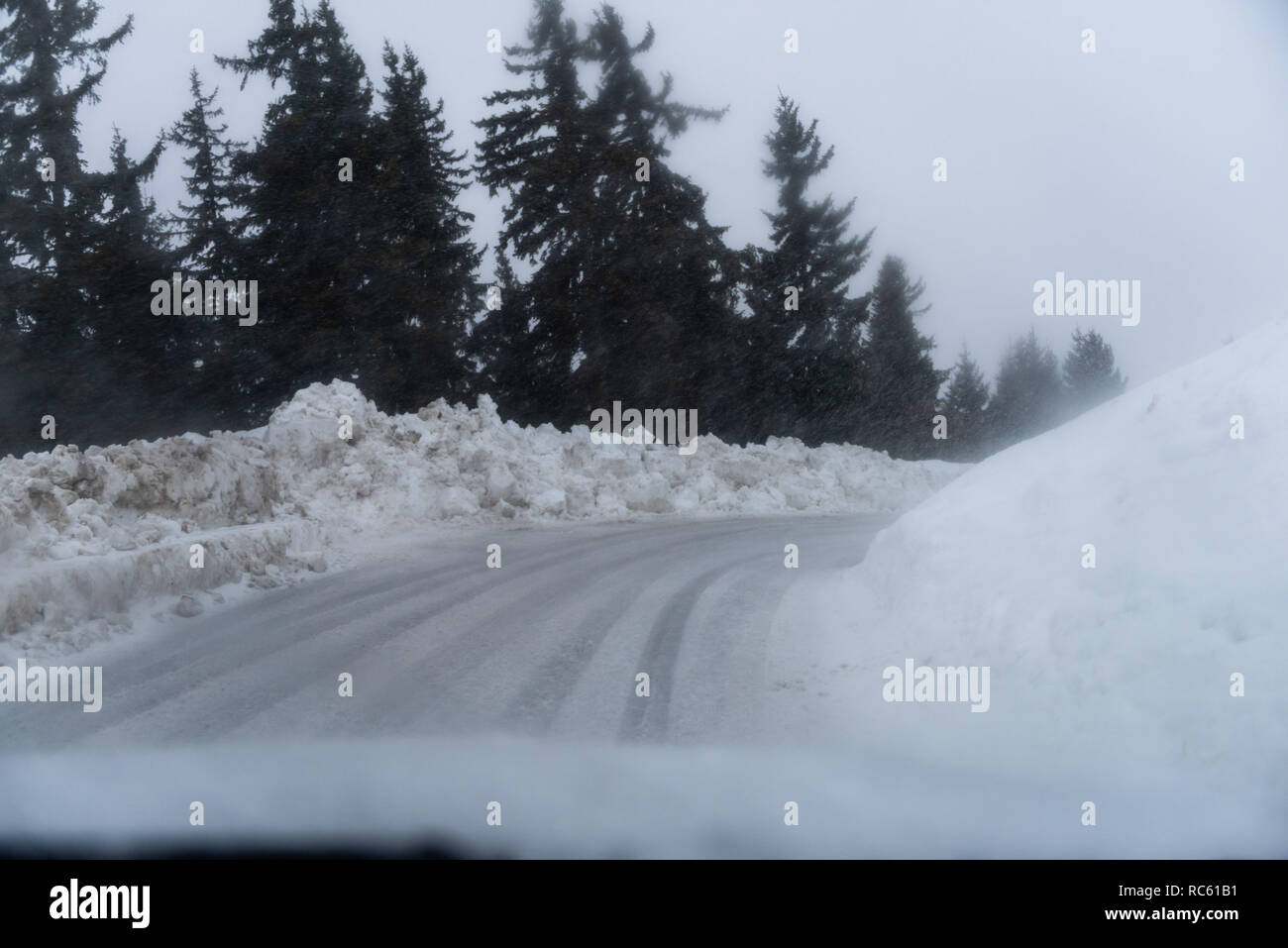 Snow covered dangerous mountain road in bad weather condition Stock ...