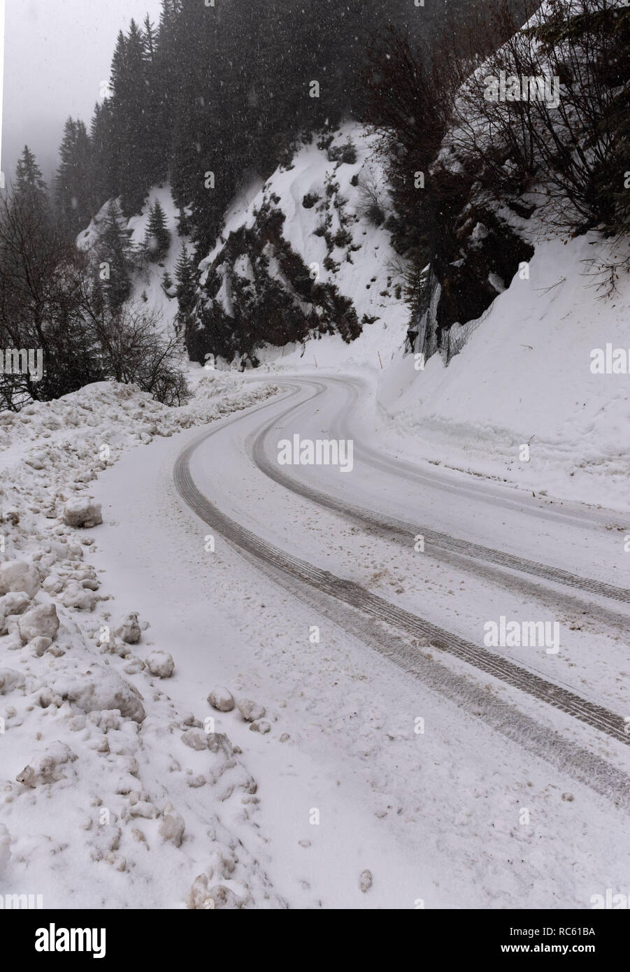Snow covered dangerous mountain road in bad weather condition Stock ...