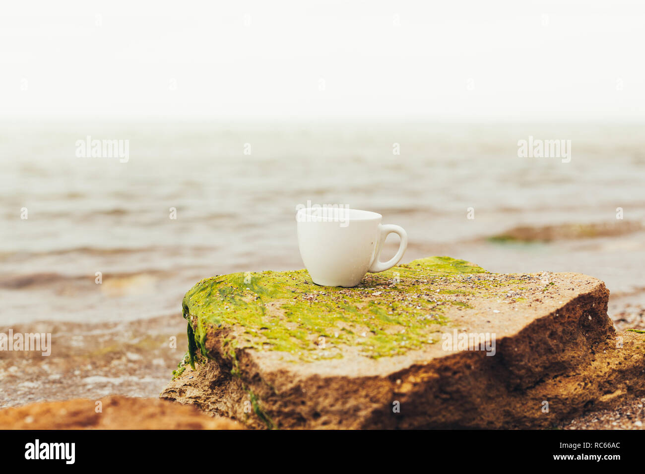 cup of coffee on the sea water and stone background. Sea freshness ...
