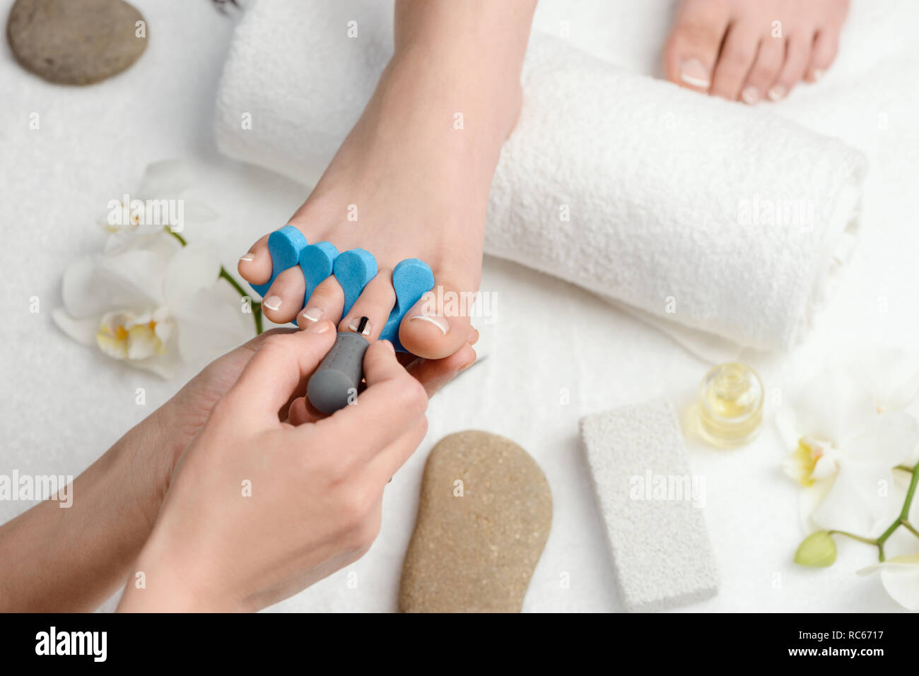 Applying polish on toe nails Stock Photo - Alamy