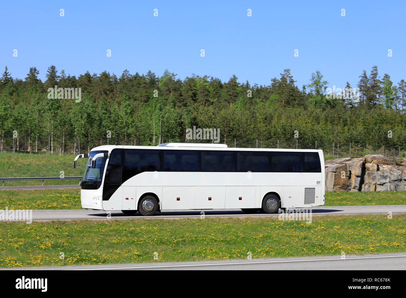 Modern, white coach bus at speed on freeway on a sunny day of summer ...