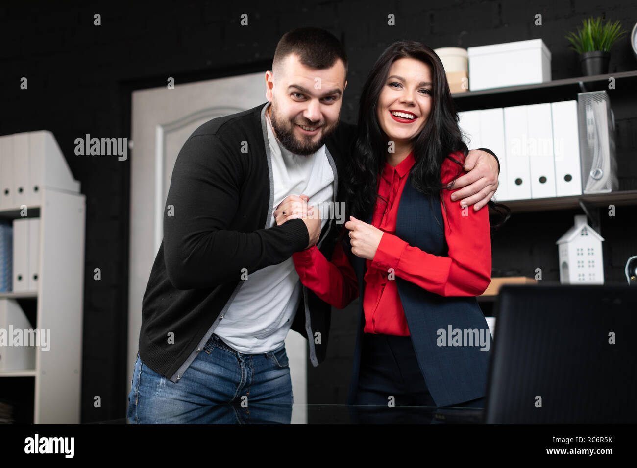 Business people hugging and shaking hands Stock Photo - Alamy