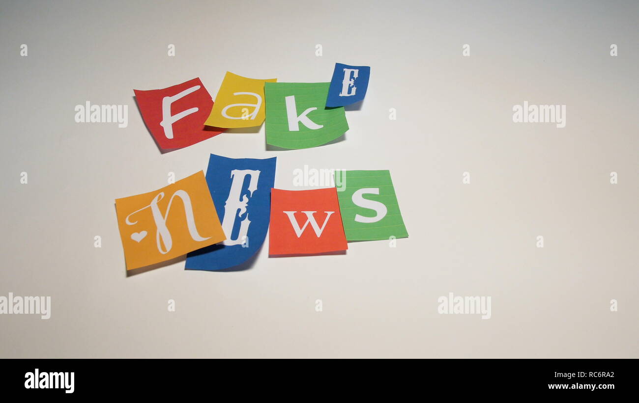 written fake news, made with pieces of newspaper is swept away by the ...