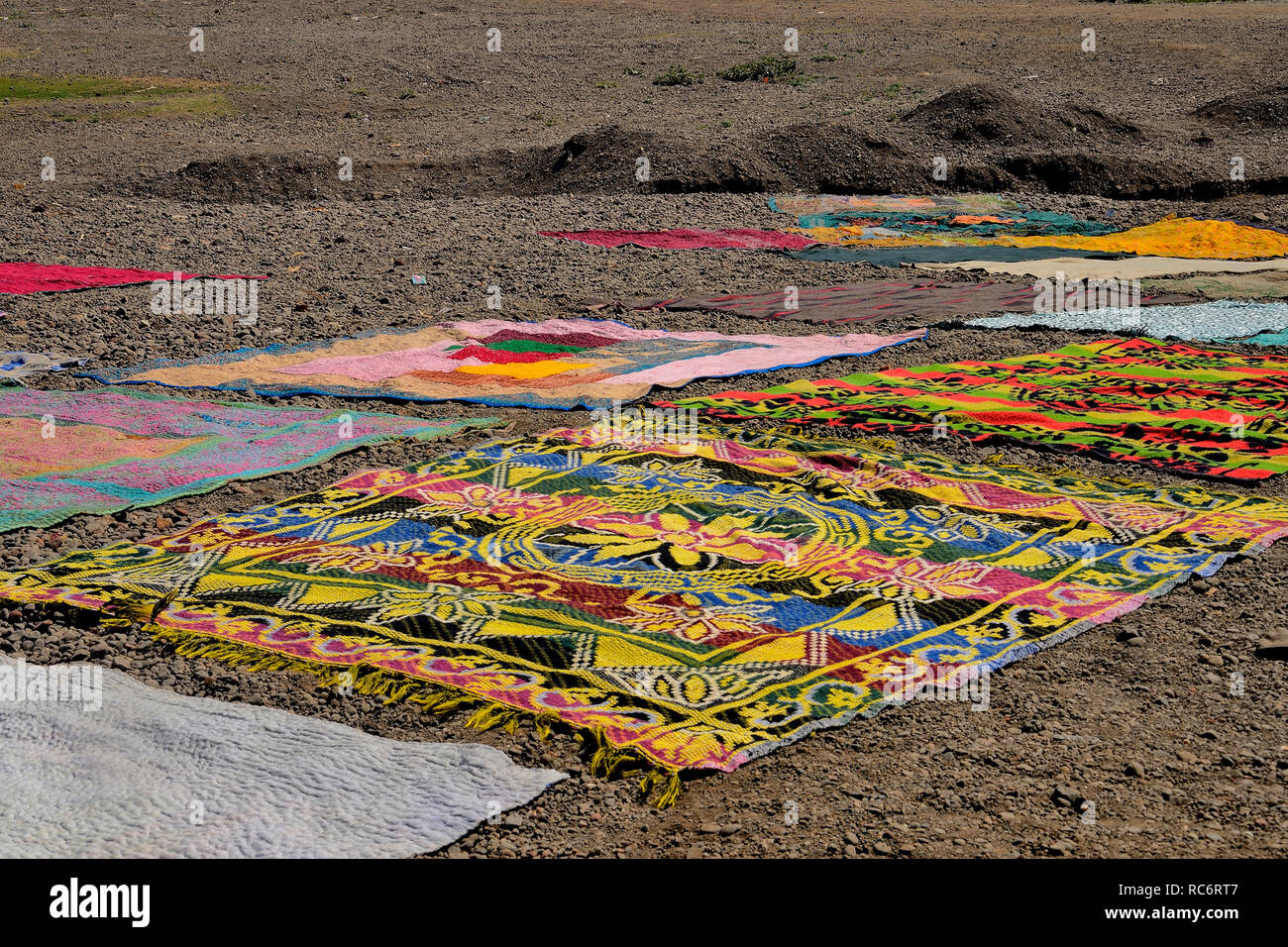 Colorful carpets and blankets displayed on the bank of Krishna and ...