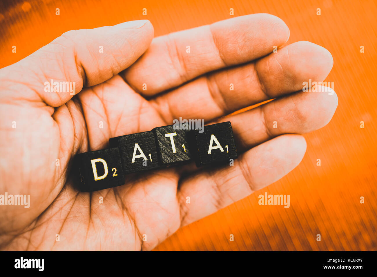 Letter cubes forming the word data on a hand Stock Photo - Alamy