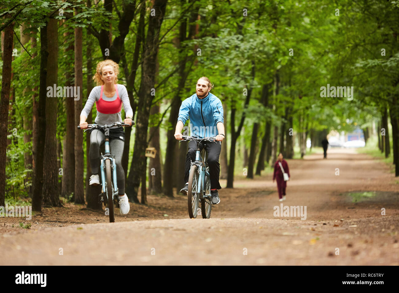 Young woman cycling in park hi-res stock photography and images - Alamy